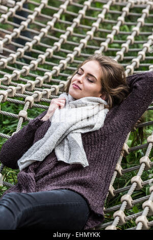 Woman resting outdoors Stock Photo - Alamy