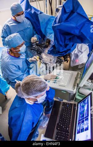 Prostate cancer radiotherapy surgery. Radiologist inserting a hollow ...