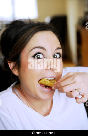 Young Woman Eating Crisps in a Park Model Released Stock Photo - Alamy