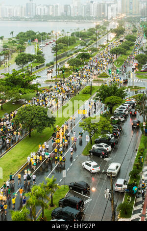 Protesters walk on Beira Mar Norte Avenue under heavy rain in the ...