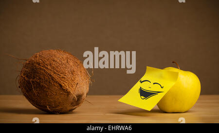 Apple with post-it note laughing on mango Stock Photo - Alamy