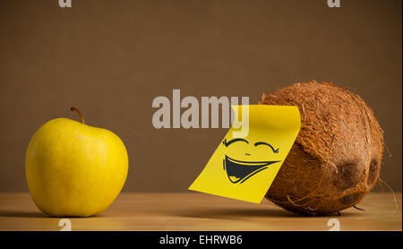 Apple with post-it note laughing on lemon Stock Photo - Alamy