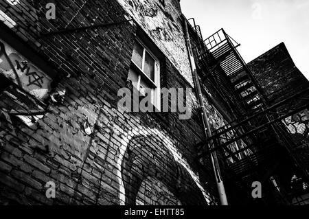 Looking up at graffiti and old staircases in Graffiti Alley, Baltimore ...