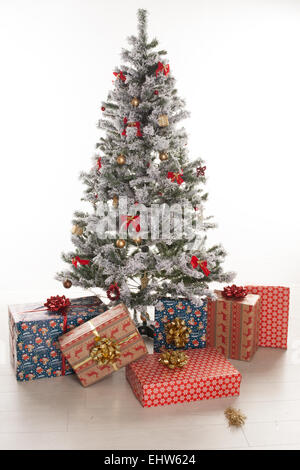 Festive gift boxes under the Christmas tree, close-up Stock Photo - Alamy