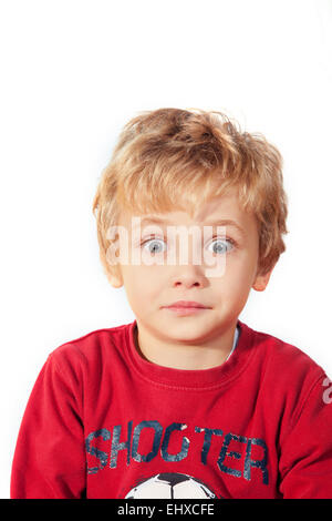 Surprised blond child with blue eyes isolated on a white background ...