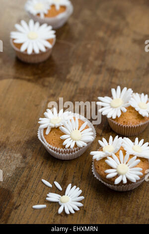 Cup cakes with white sugar blossoms and tulle Stock Photo - Alamy