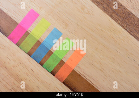 Notes five colours in diagonal on wood background Stock Photo - Alamy