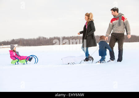 Mother pulling children on sled in snow Stock Photo: 48904690 - Alamy