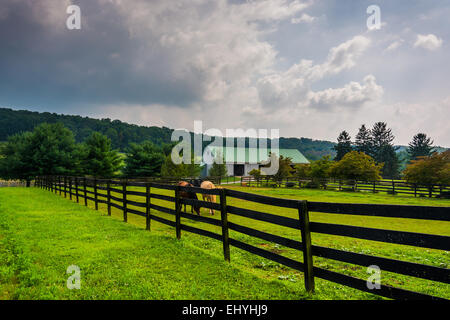 Dark clouds over a barn and farm fields in rural Southern York County ...