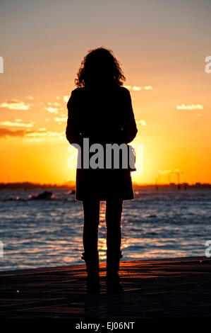 Woman watching the sunset on the Zattere promenade, Venice, Italy Stock ...