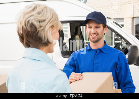 Delivery driver man loading parcels onto trolley from DPD delivery van ...