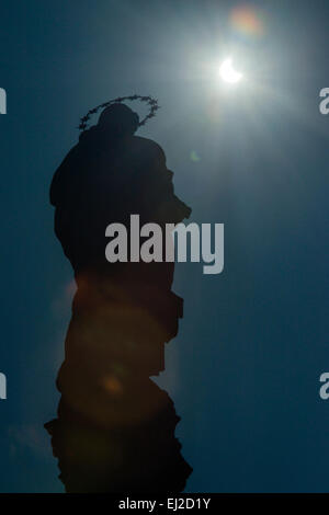 The solar eclipse is seen behind a statue of late Chinese leader Mao ...