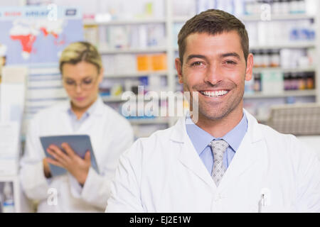 Happy pharmacist looking at camera Stock Photo - Alamy
