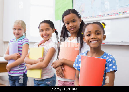 Pupils smiling at camera during class Stock Photo - Alamy