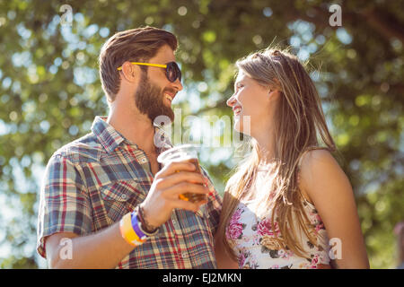 Smiling hipster couple in sunglasses hugging and having fun outdoors in ...