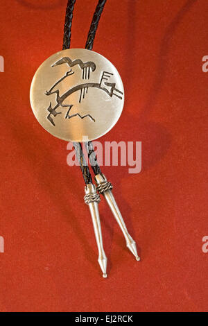 A Navajo Yei Bichei figure, or Rainbow God, on a man's bolo tie from ...