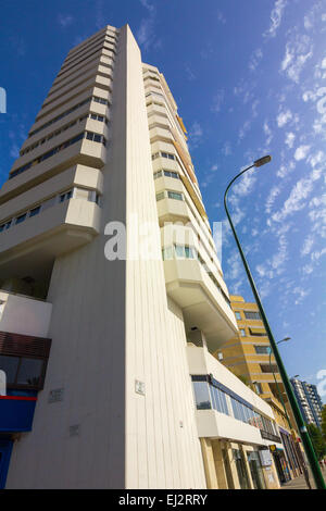 Modern apartment building facade with white walls, large windows and ...