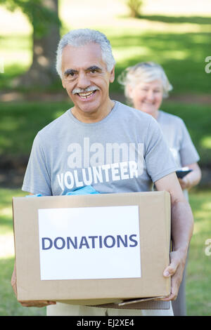 Senior volunteer man holding your donation matters celebrating victory ...