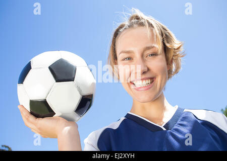 Pretty football player smiling at camera Stock Photo - Alamy