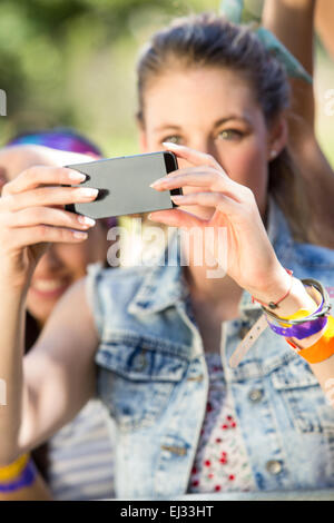 Excited music fan taking photo Stock Photo - Alamy
