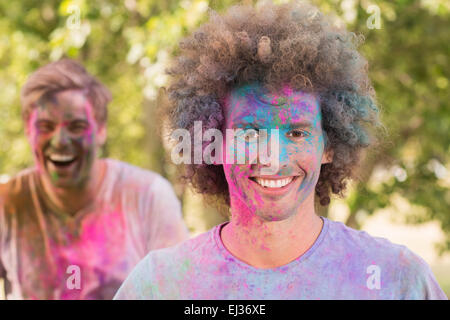Happy friends covered in powder paint Stock Photo - Alamy