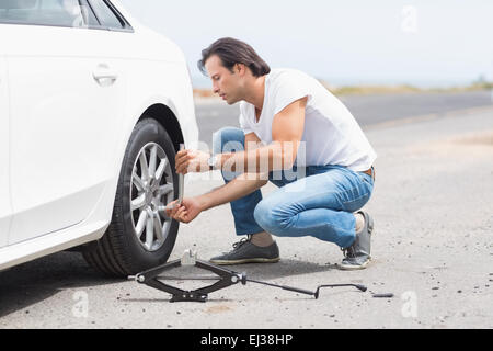 Man changing wheel after a car breakdown Stock Photo - Alamy