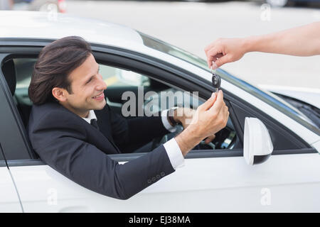 Businessman getting his new car key Stock Photo - Alamy