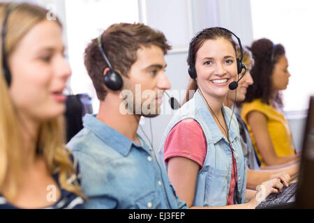 Students using headsets in computer class Stock Photo - Alamy