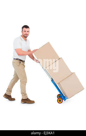 delivery man pushing a trolley with boxes Stock Photo - Alamy