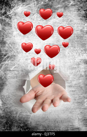 Composite image of hand bursting through paper Stock Photo - Alamy