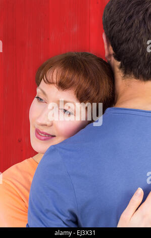 Composite image of happy couple hugging and smiling at each other Stock ...