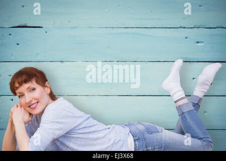 Composite image of woman lying on couch Stock Photo - Alamy
