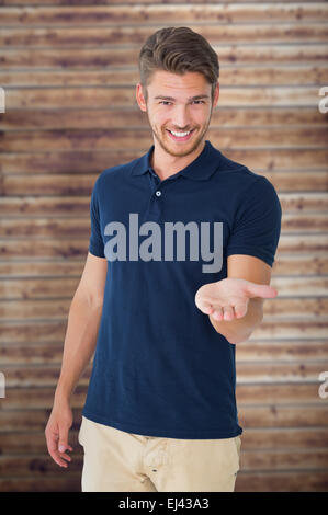 A smiling man holding out his hand Stock Photo - Alamy