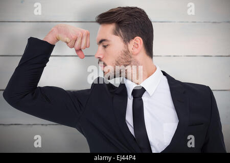 A man tensing his bicep muscle Stock Photo - Alamy