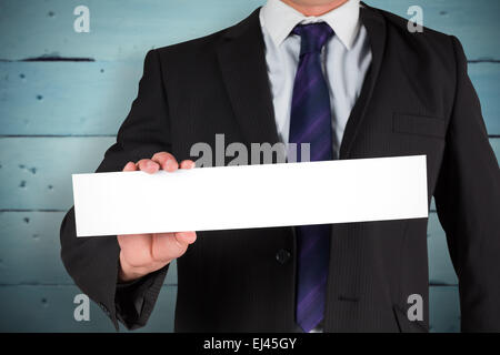 Composite image of businessman showing card in front of his head Stock ...