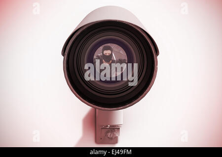 Composite image of hacker reaching out to camera Stock Photo - Alamy