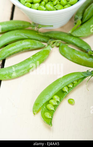 hearthy fresh green peas over a rustic wood table Stock Photo - Alamy