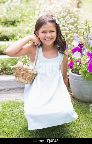 Portrait of smiling caucasian girl collecting eggs from hen house in ...