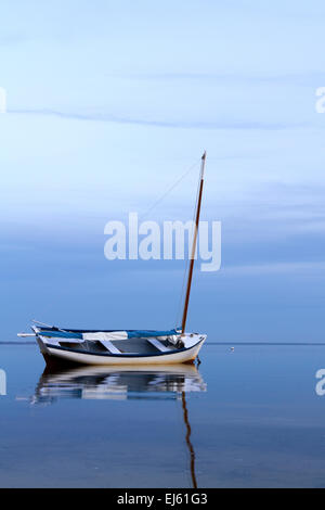 A Cape Cod, Massachusetts beach scene with boats on moorings, tidal ...