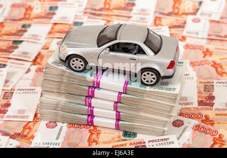 Car on money stack Stock Photo - Alamy