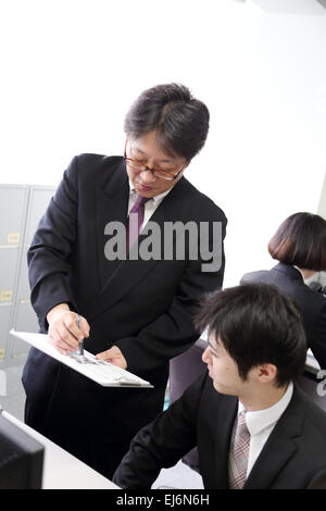 Young Japanese businessman working with his boss Stock Photo - Alamy