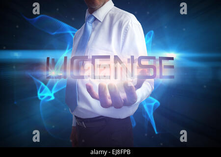 Businessman presenting the word license Stock Photo - Alamy