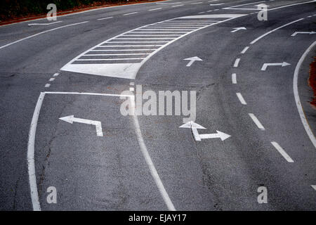 Road with turn direction lane marks Stock Photo - Alamy