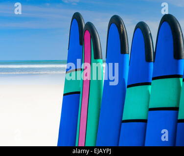 Color surf boards in a stack by ocean Stock Photo - Alamy