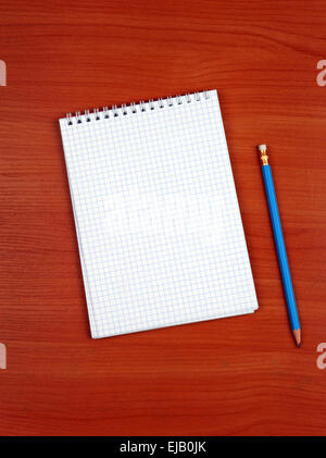 empty writing pad with pen on a wooden table Stock Photo - Alamy
