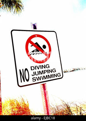 Danger no diving or swiming sign on the wooden pole in hedge Stock ...