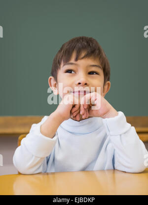 Cute boy thinking in classroom Stock Photo - Alamy