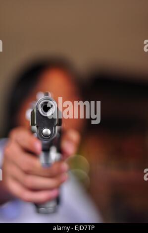 Gunman aiming a gun towards camera, selective focus Stock Photo - Alamy