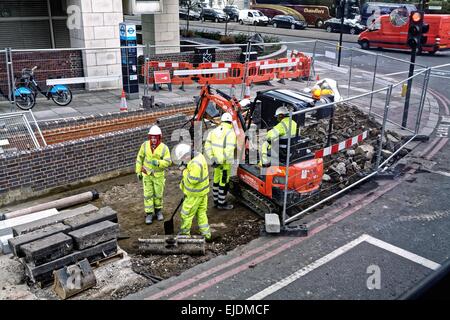 London, England, UK. Men digging up the street in central London Stock ...