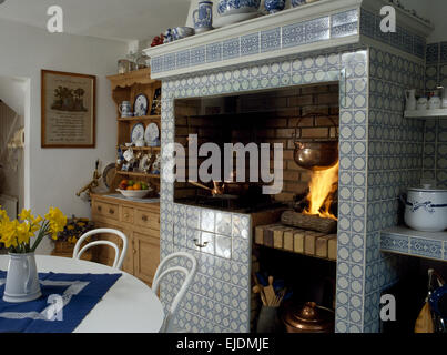 The kitchen, dining room and fireplace in a restored 17th century ...